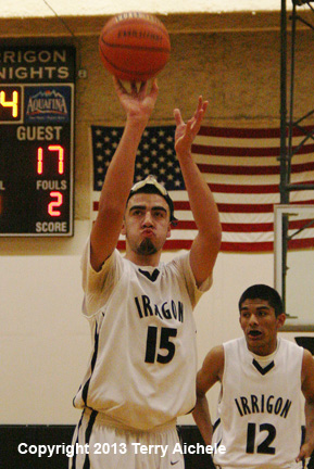 LEFT - Adrian Romero of Irrigon, number 1 in white, shoots a short jump ...