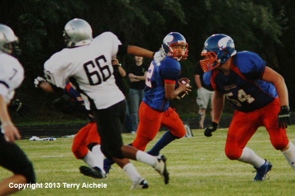 LEFT - Umatilla quarterback Edgar Zamarrapa, number 12 in blue, rolls ...