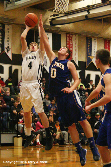 LEFT - Fredy Vera of Irrigon shoots a trey late in the second period ...