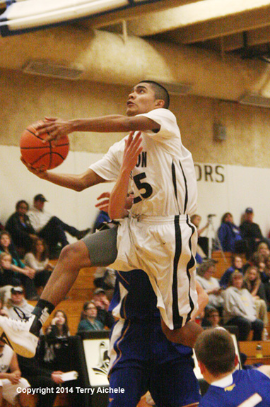 LEFT - Adrian Romero of Irrigon shoots a jumper.[img_7788]RIGHT ...