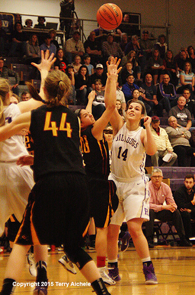 LEFT - Maddy Juul of Hermiston makes a shot while surrounded by ...