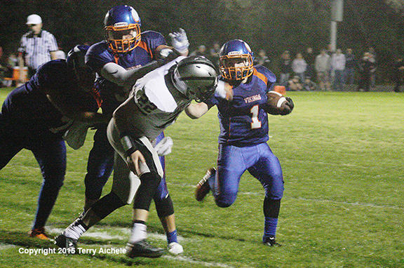 LEFT - Hunter Cook of Umatilla, in blue, carries the ball during a run ...